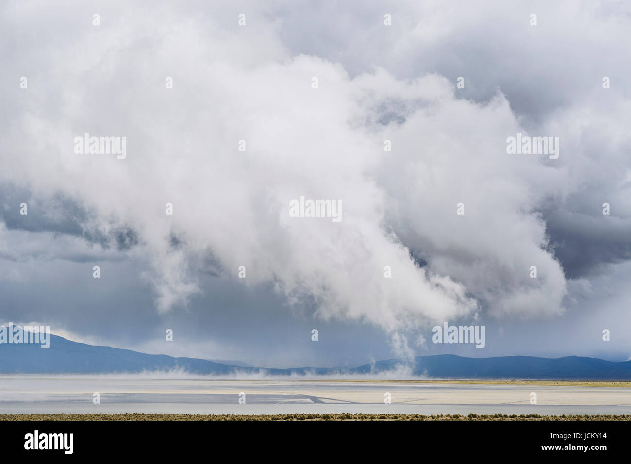 Dramatic evaporation of water on a salt lake and stormy sky. High ...