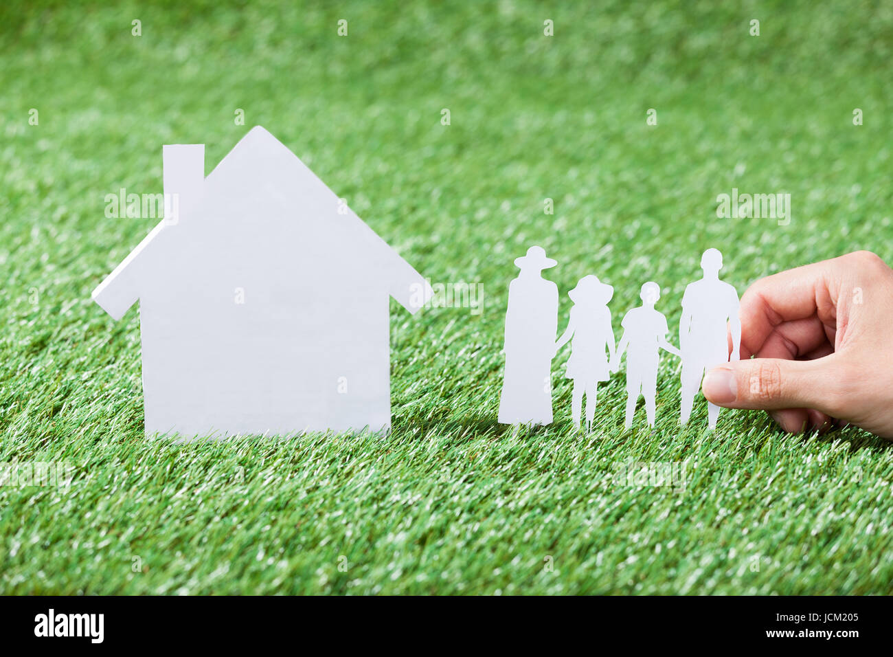 Model of family and house in grass Stock Photo - Alamy