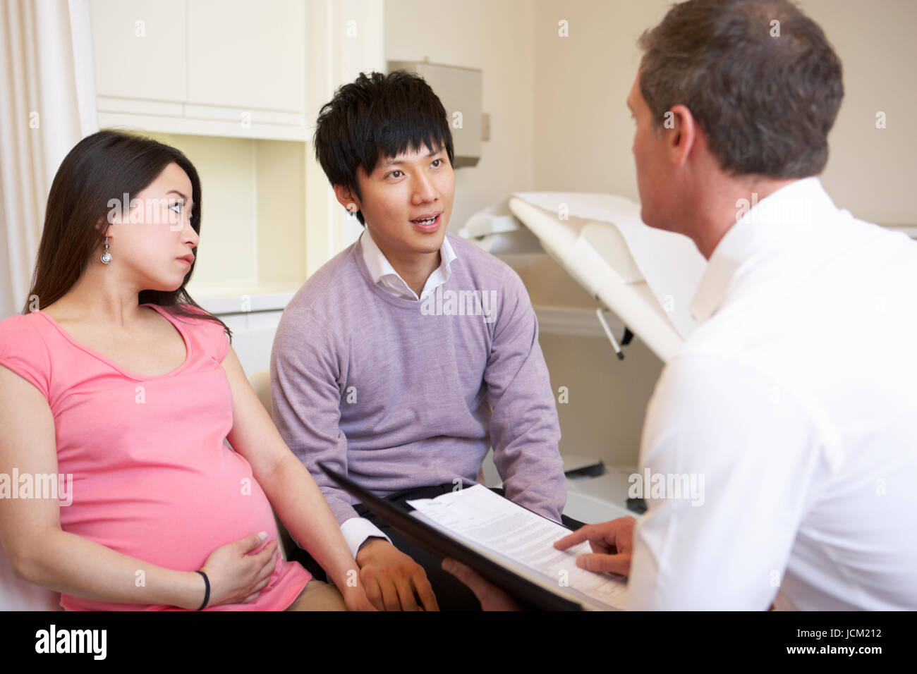 Couple Meeting With Obstetrician In Clinic Stock Photo - Alamy