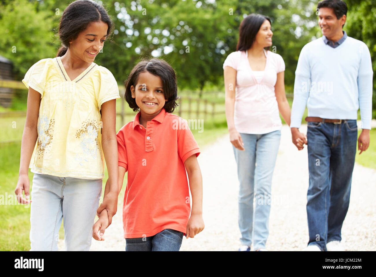 Indian Family Walking In Countryside Stock Photo - Alamy