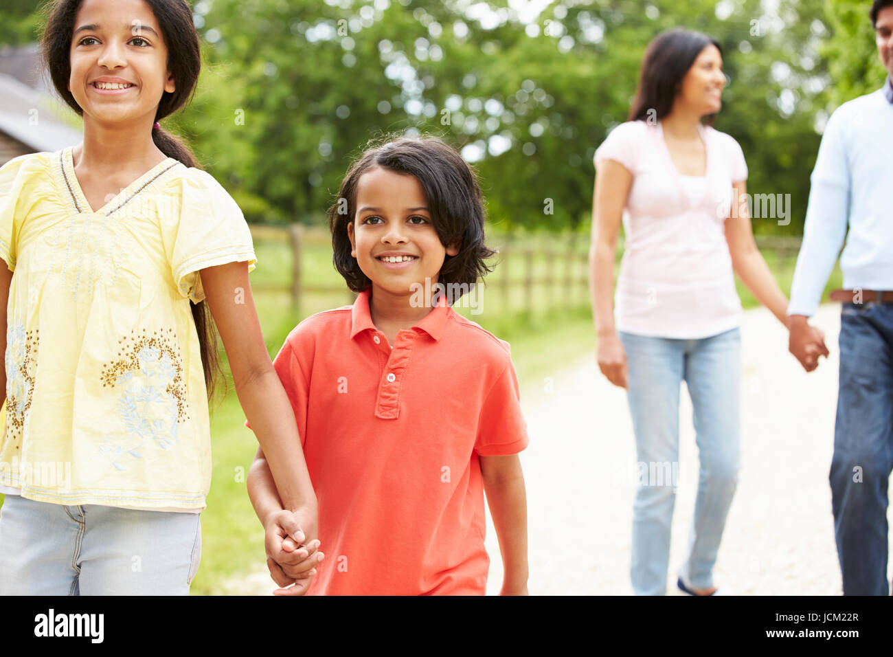 Indian Family Walking In Countryside Stock Photo - Alamy