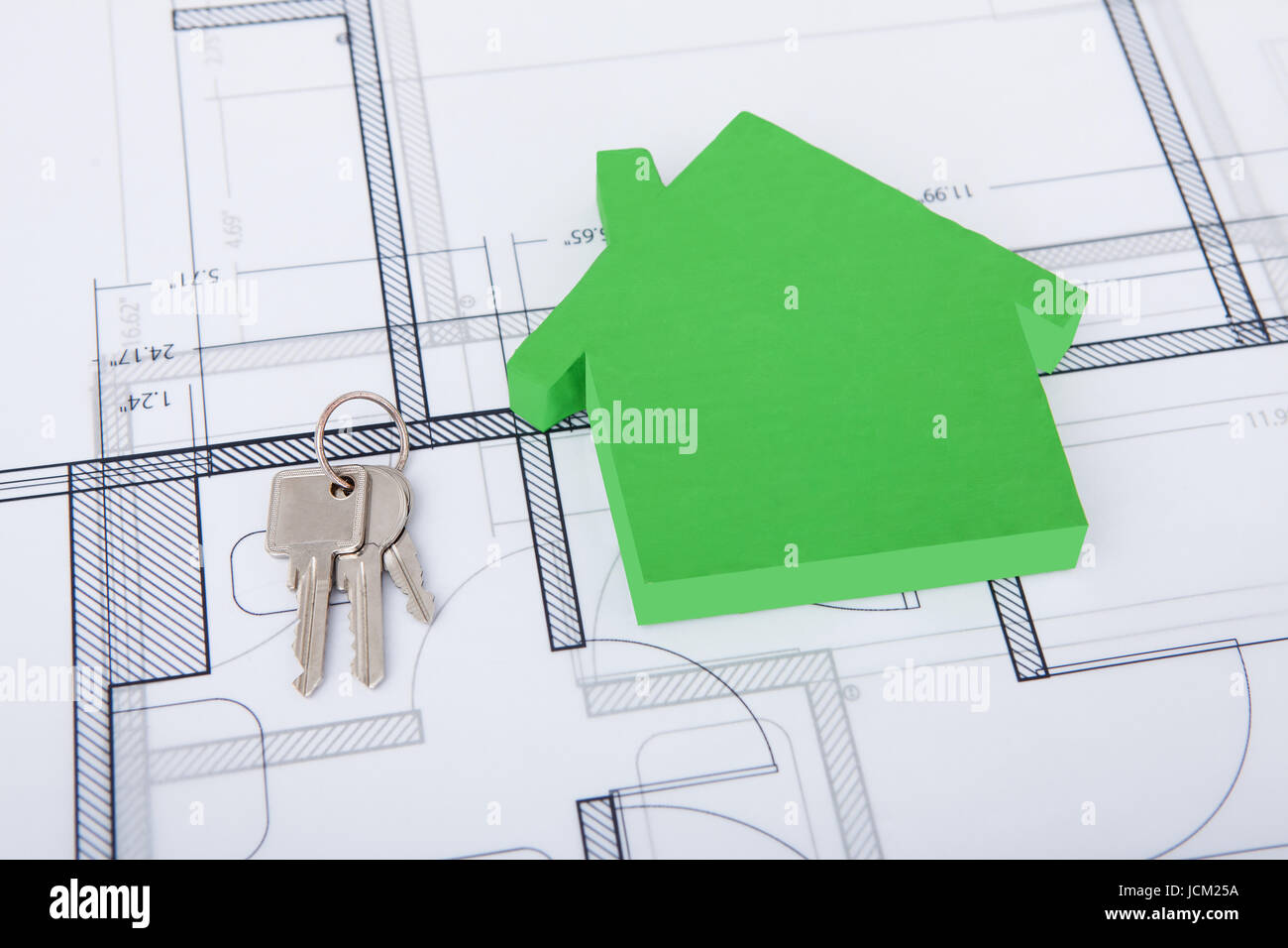 Closeup of green house and keys on blueprint Stock Photo - Alamy