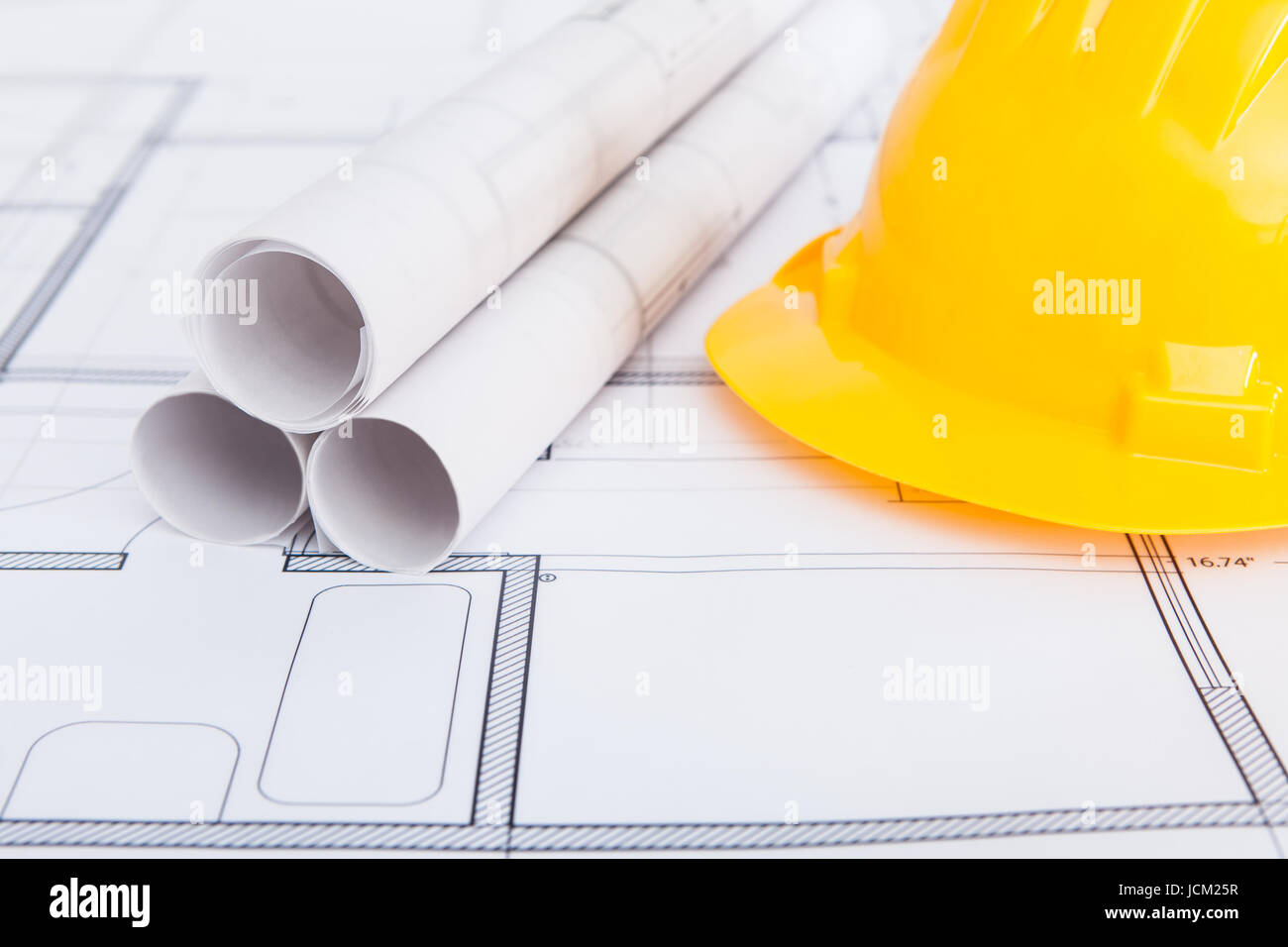 Closeup photo of hard hat and blueprints Stock Photo - Alamy