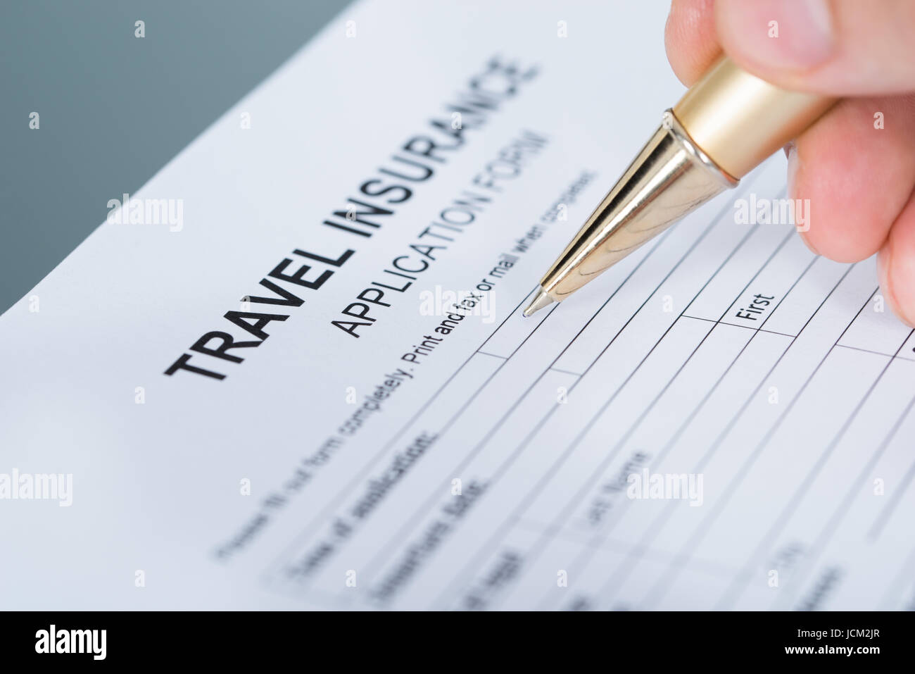 Hand filling travel insurance form. Closeup shot Stock Photo - Alamy