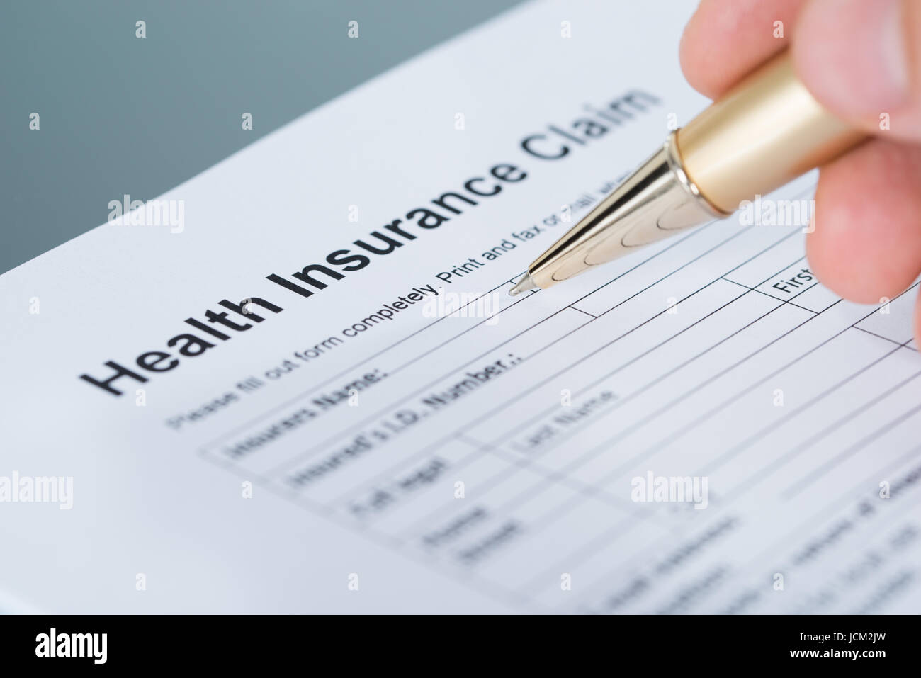 Hand filling health insurance claim form. Closeup shot Stock Photo - Alamy