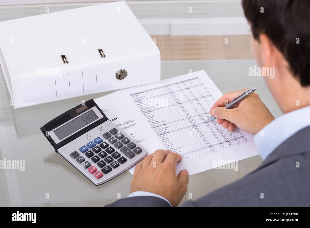 Accountant calculating finances. Over the shoulder view Stock Photo - Alamy