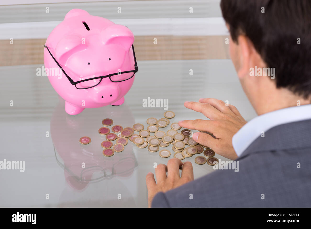 Man counting coins. Over the shoulder view Stock Photo - Alamy
