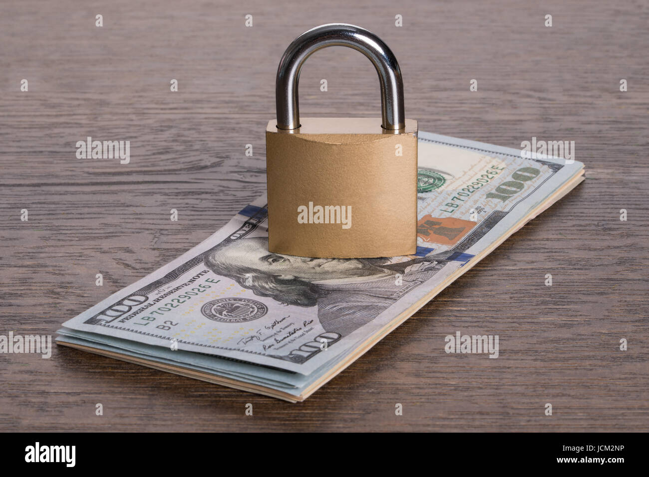 Dollar bills and lock in money security concept Stock Photo - Alamy