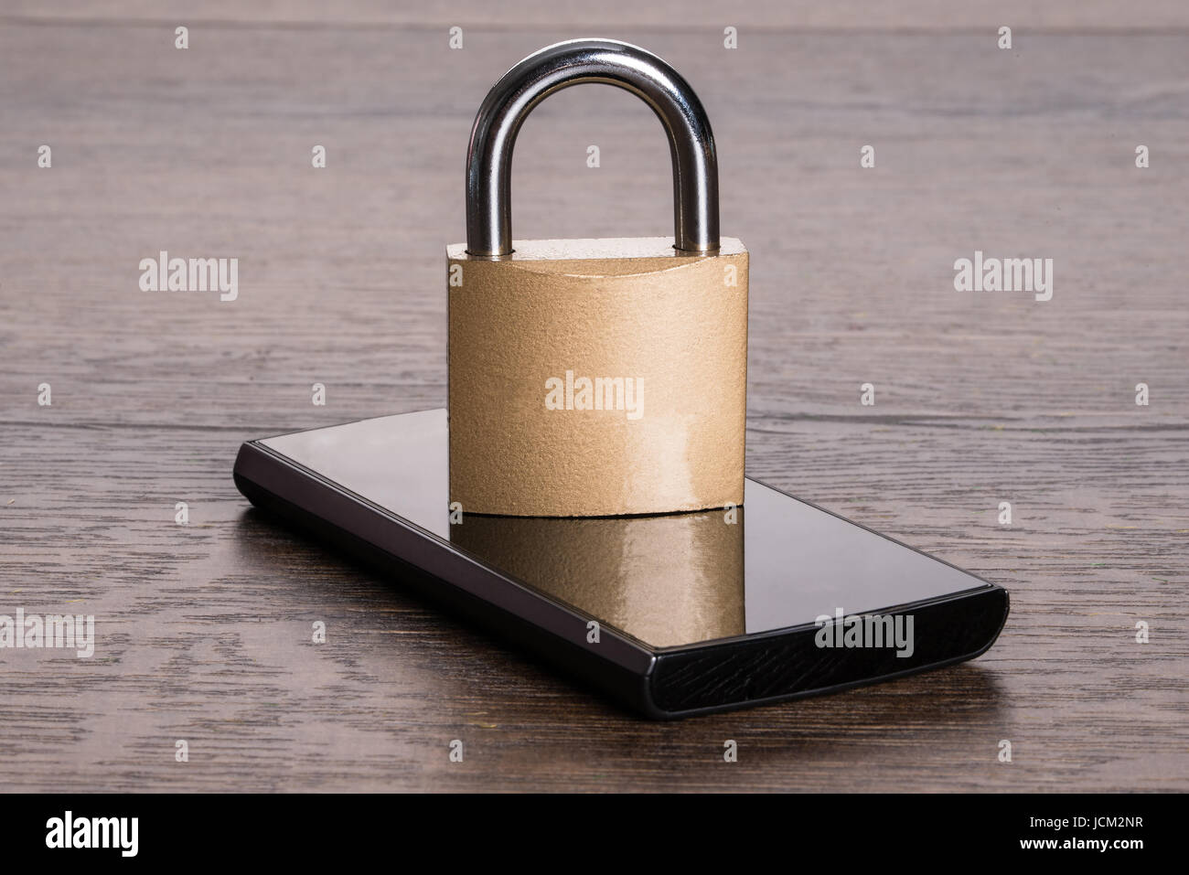 Photo of mobile phone and padlock. Security concept Stock Photo - Alamy