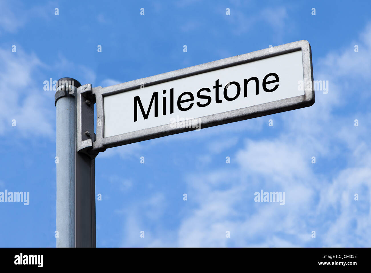 Low angle view of signpost with Milestone sign against sky Stock Photo ...