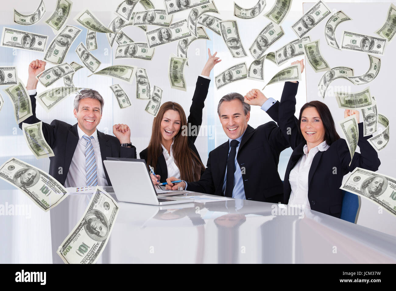 Portrait of successful business people with money rain in conference ...