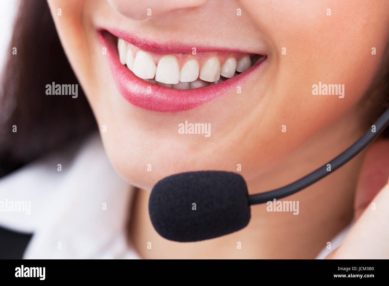 Closeup of smiling female customer service representative with ...
