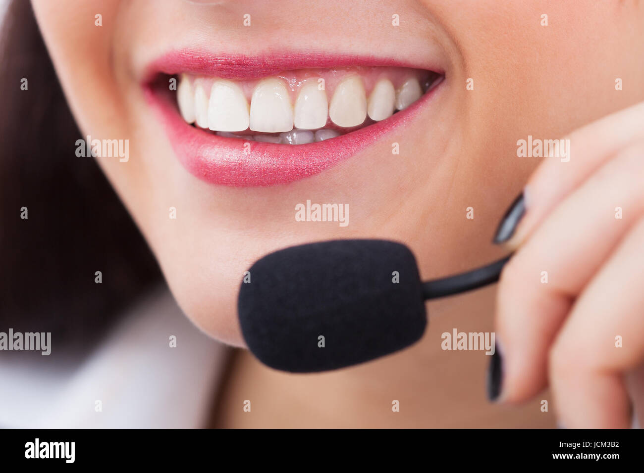 Closeup of smiling female customer service representative with ...