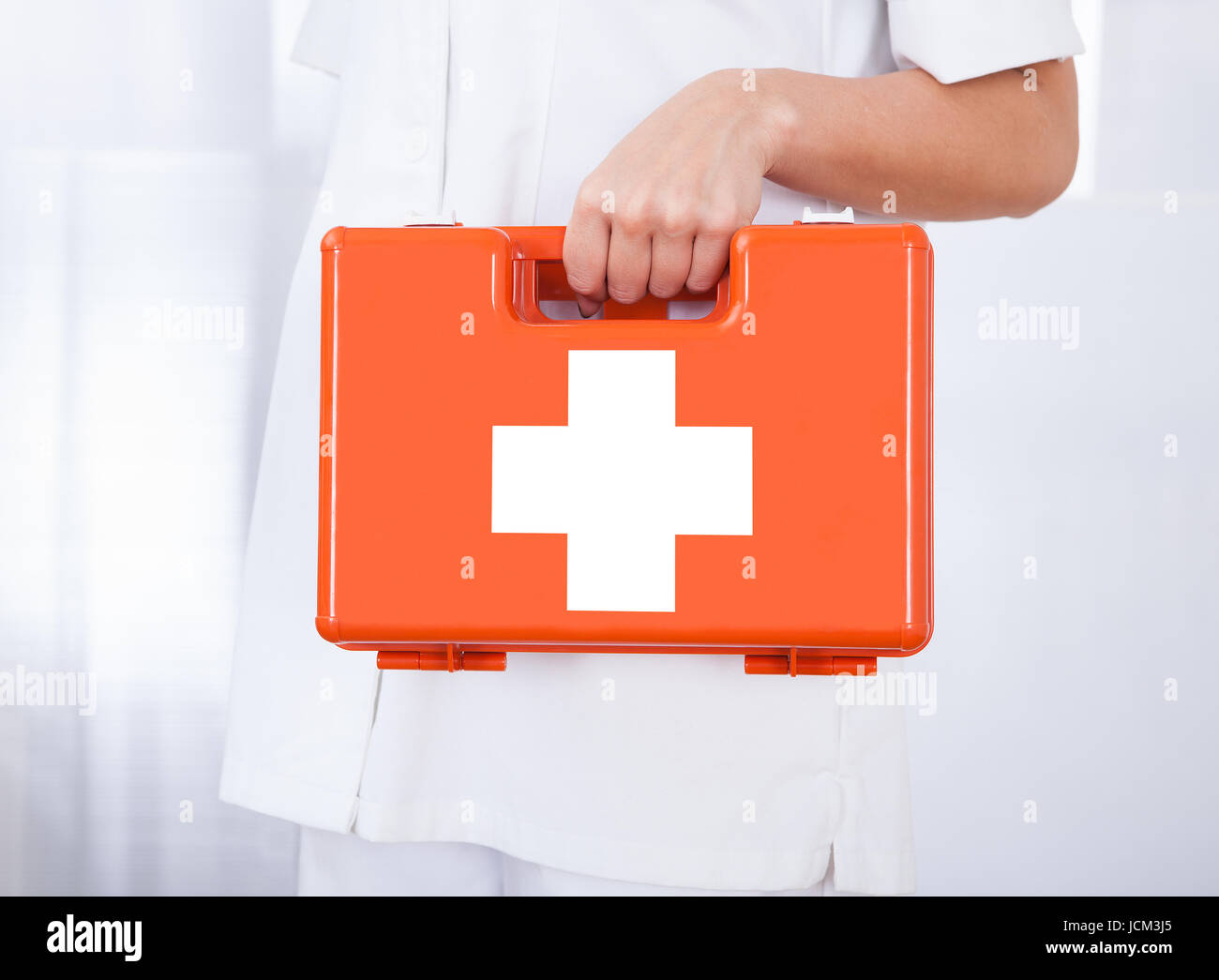 Female doctor holding first aid box in hospital Stock Photo - Alamy
