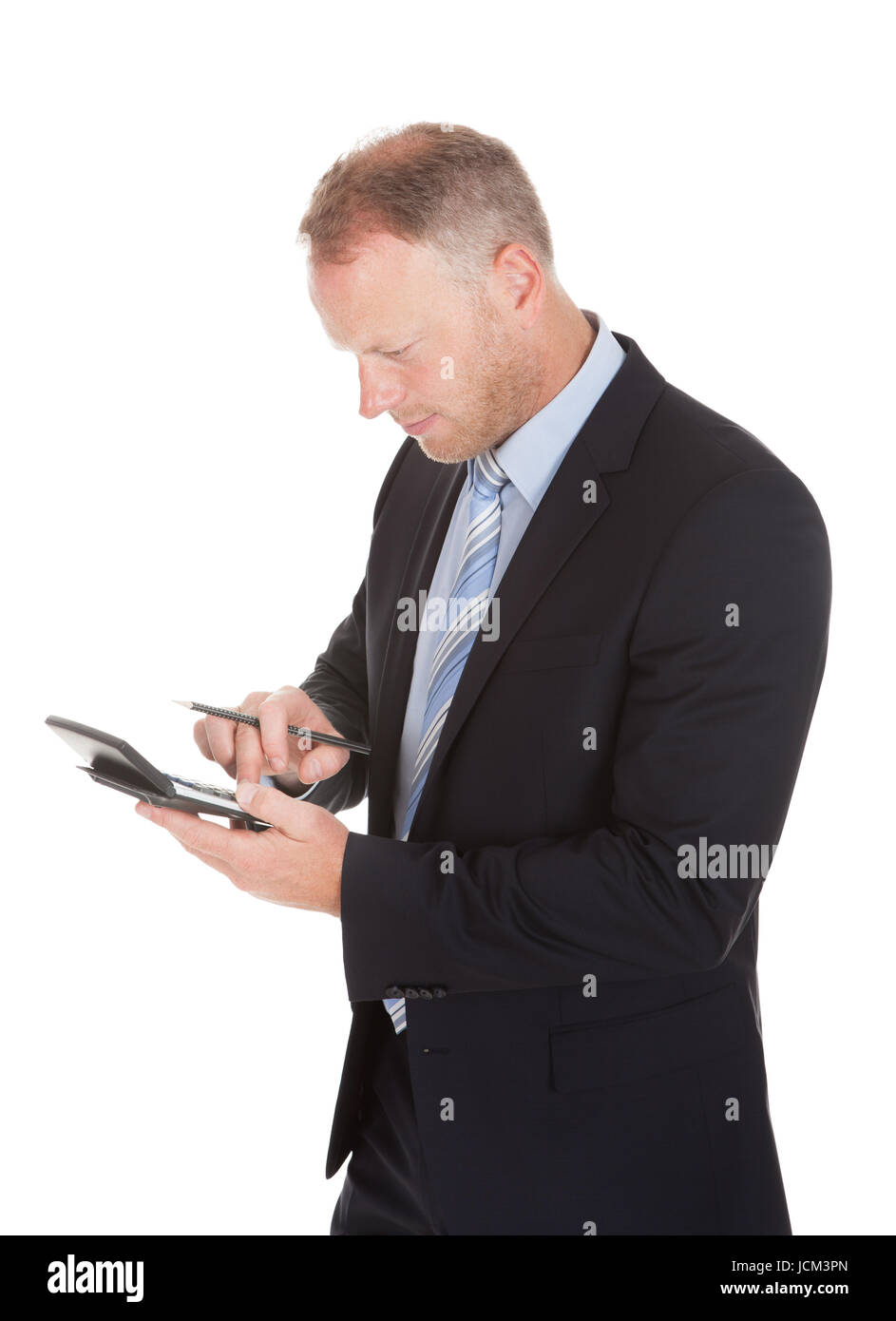 Mid adult businessman using calculator over white background Stock ...