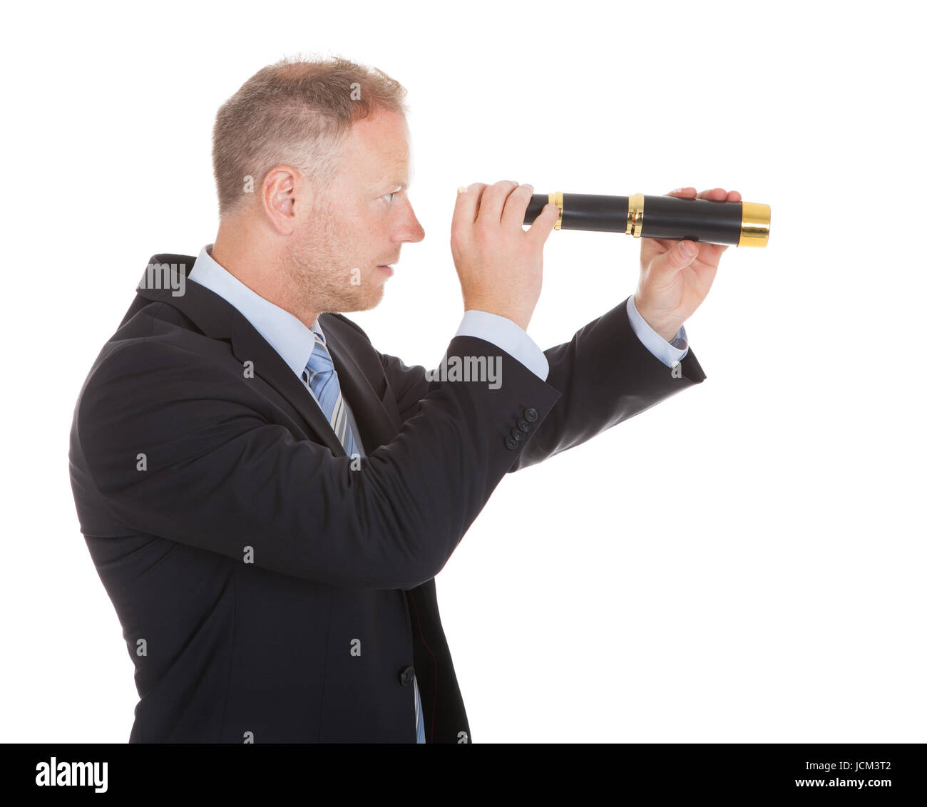 Side view of mid adult businessman looking through handheld telescope ...