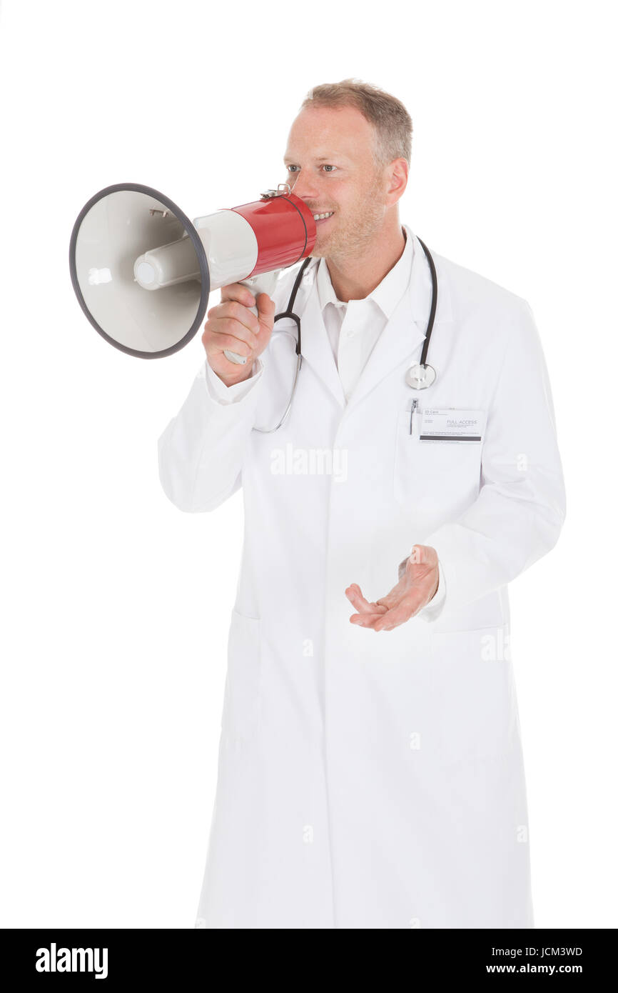 Young male doctor screaming into megaphone over white background Stock ...
