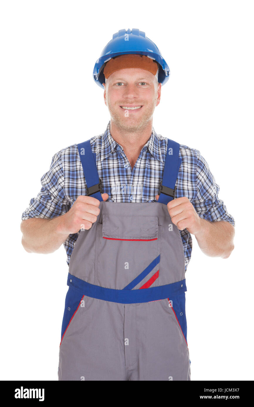 Full length portrait of manual worker standing with hands on hip over ...