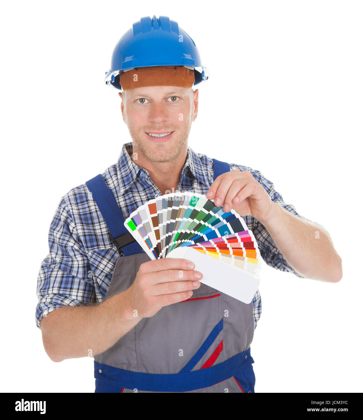 Portrait of confident mid adult male handyman showing color swatches ...