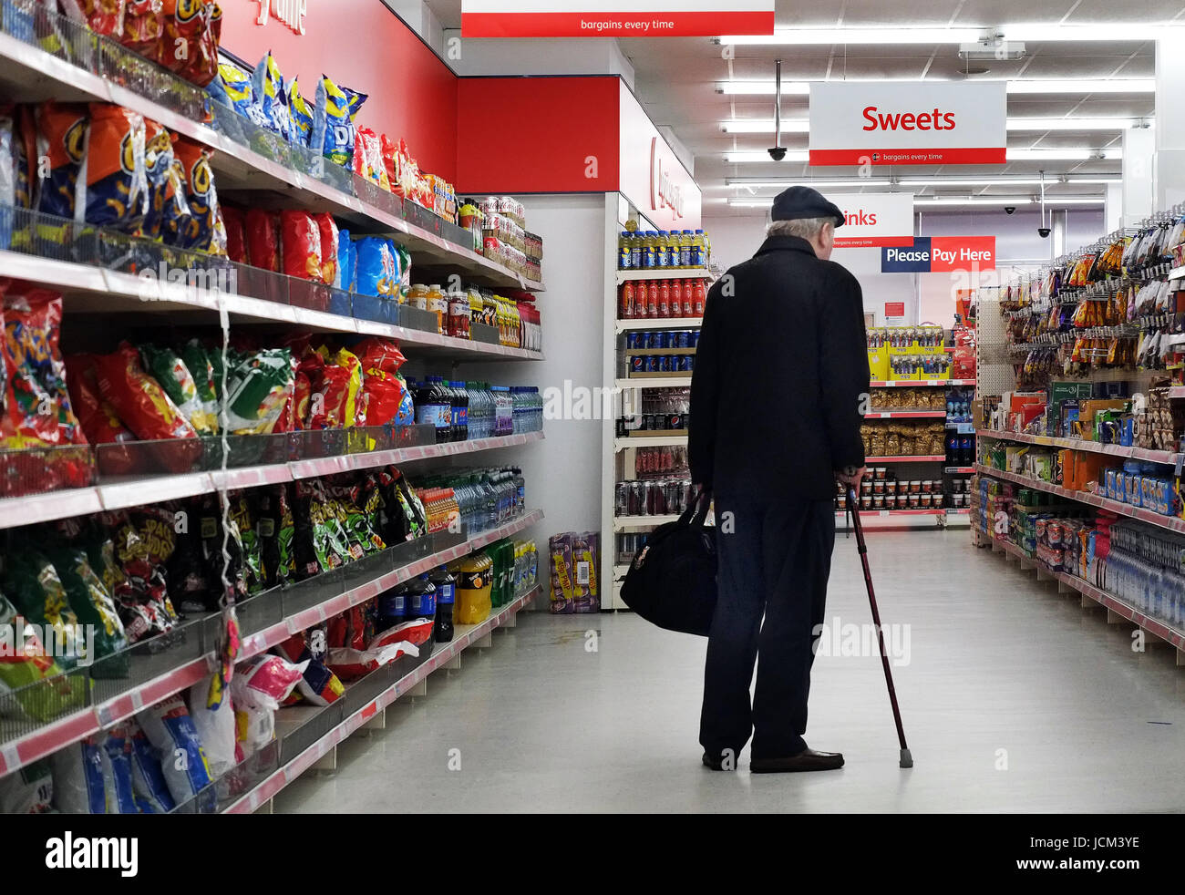 Old man in food shop isle looking at products to buy.shopper Stock ...