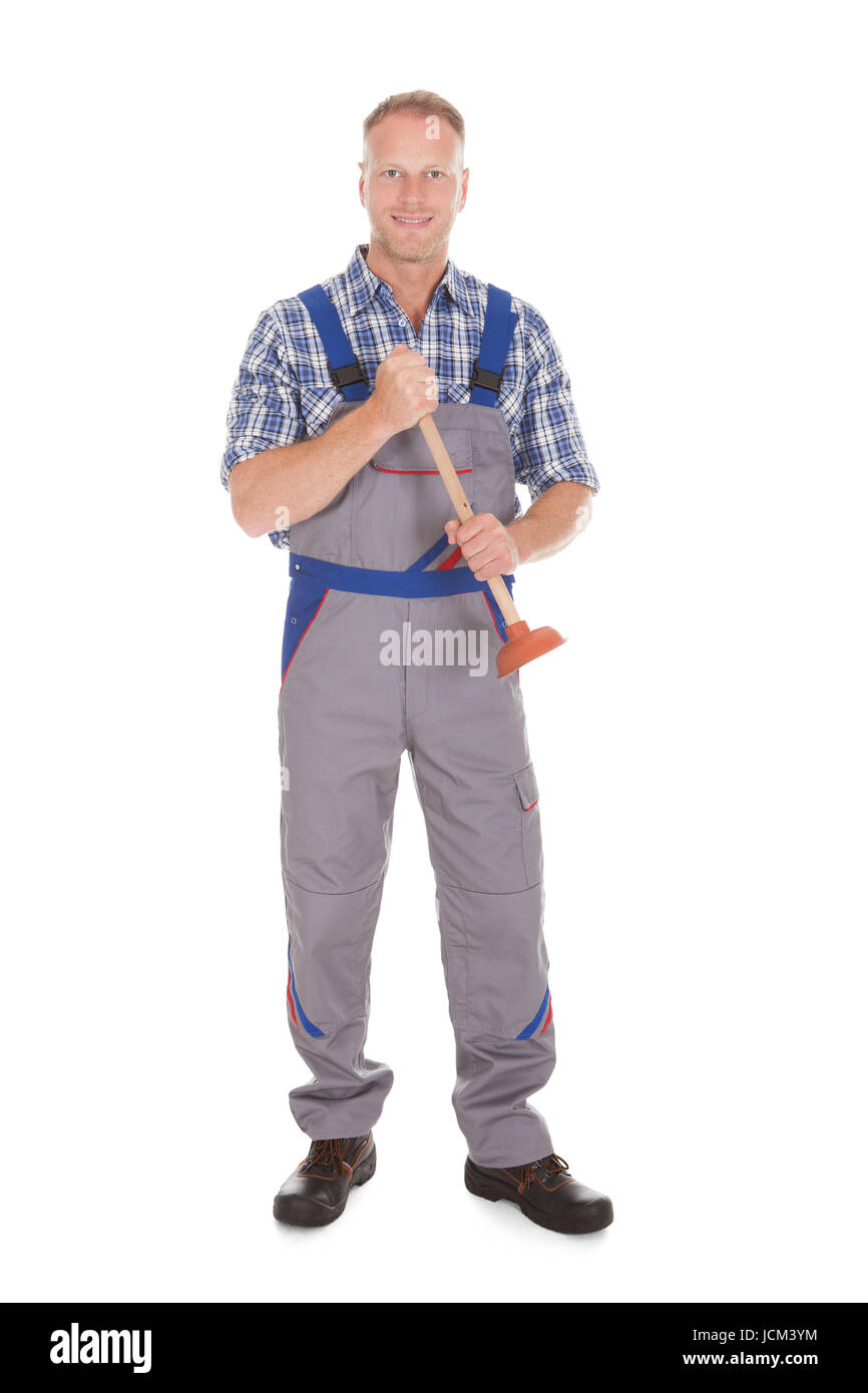 Full length portrait of excited young male plumber holding plunger over ...