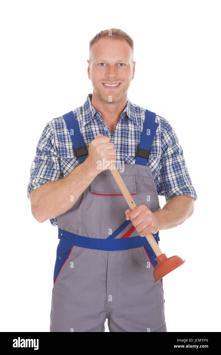 Full length portrait of excited young male plumber holding plunger over ...