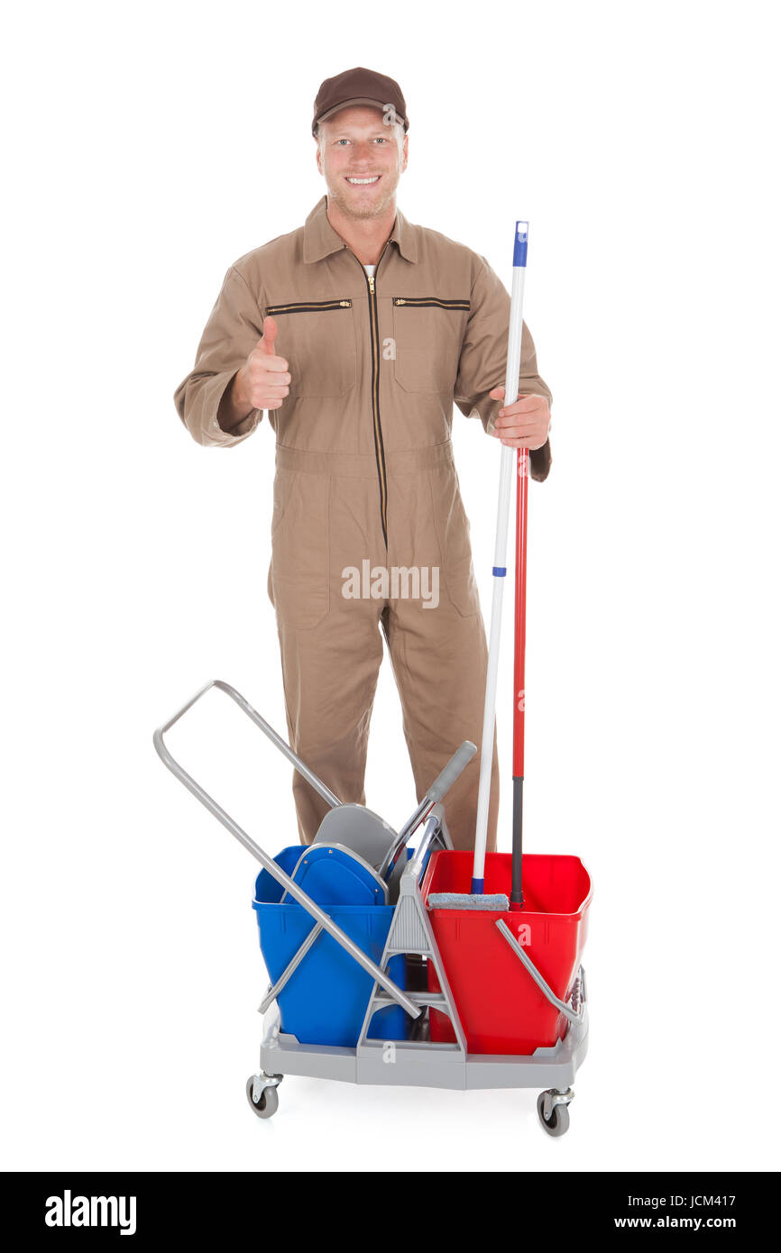 Full length portrait of confident cleaner showing thumbs up over white ...