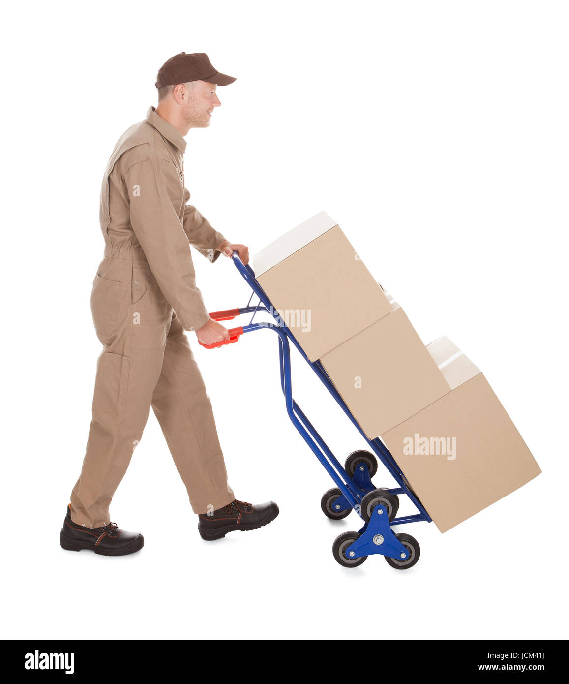 Full length portrait of delivery postman pushing machine on cart over ...