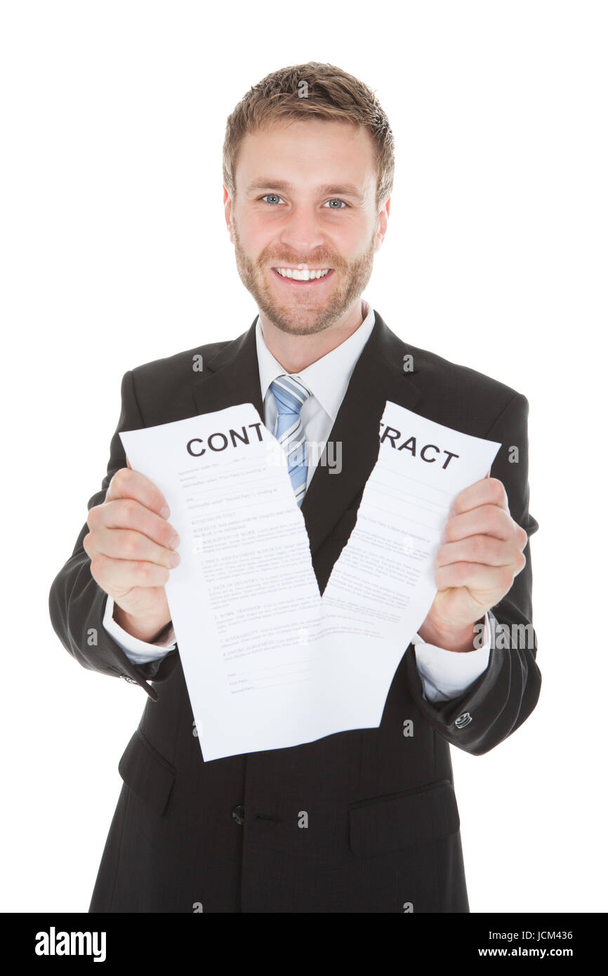 Portrait of happy businessman tearing contract paper over white ...