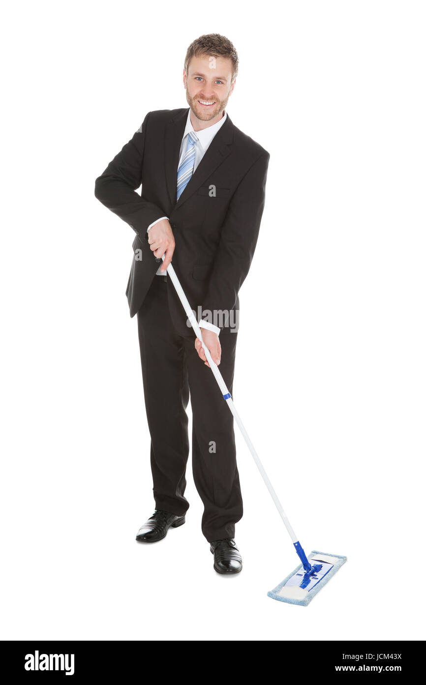 Full length portrait of happy businessman mopping floor over white ...