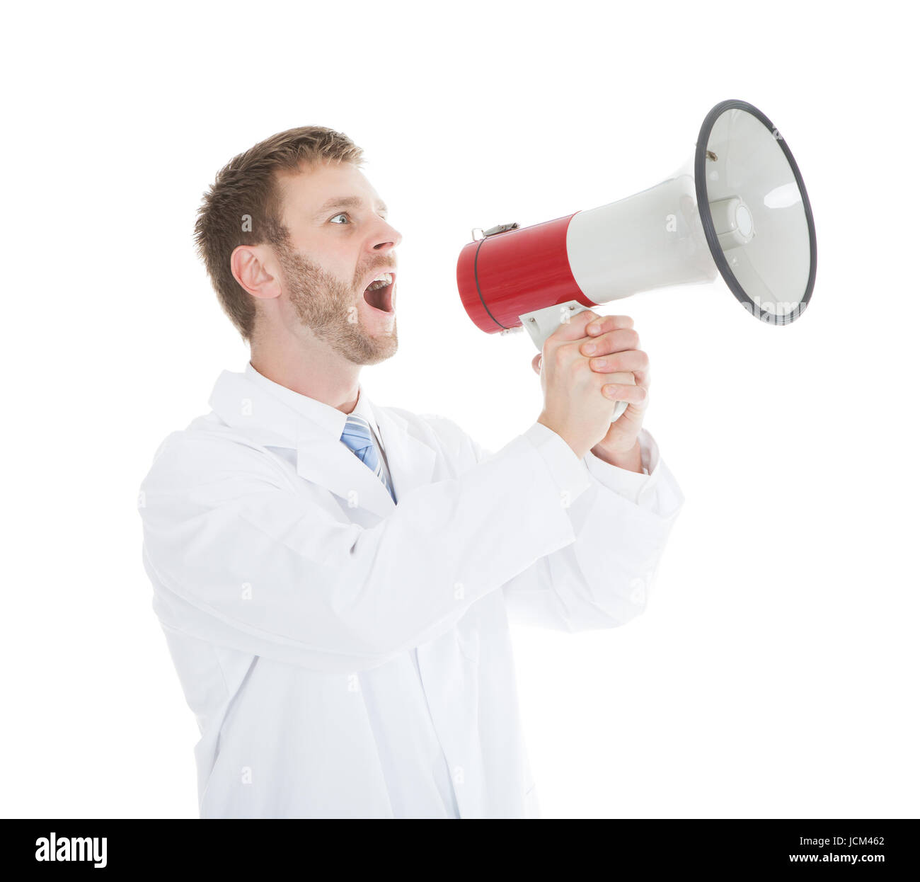 Young male doctor screaming into megaphone over white background Stock ...
