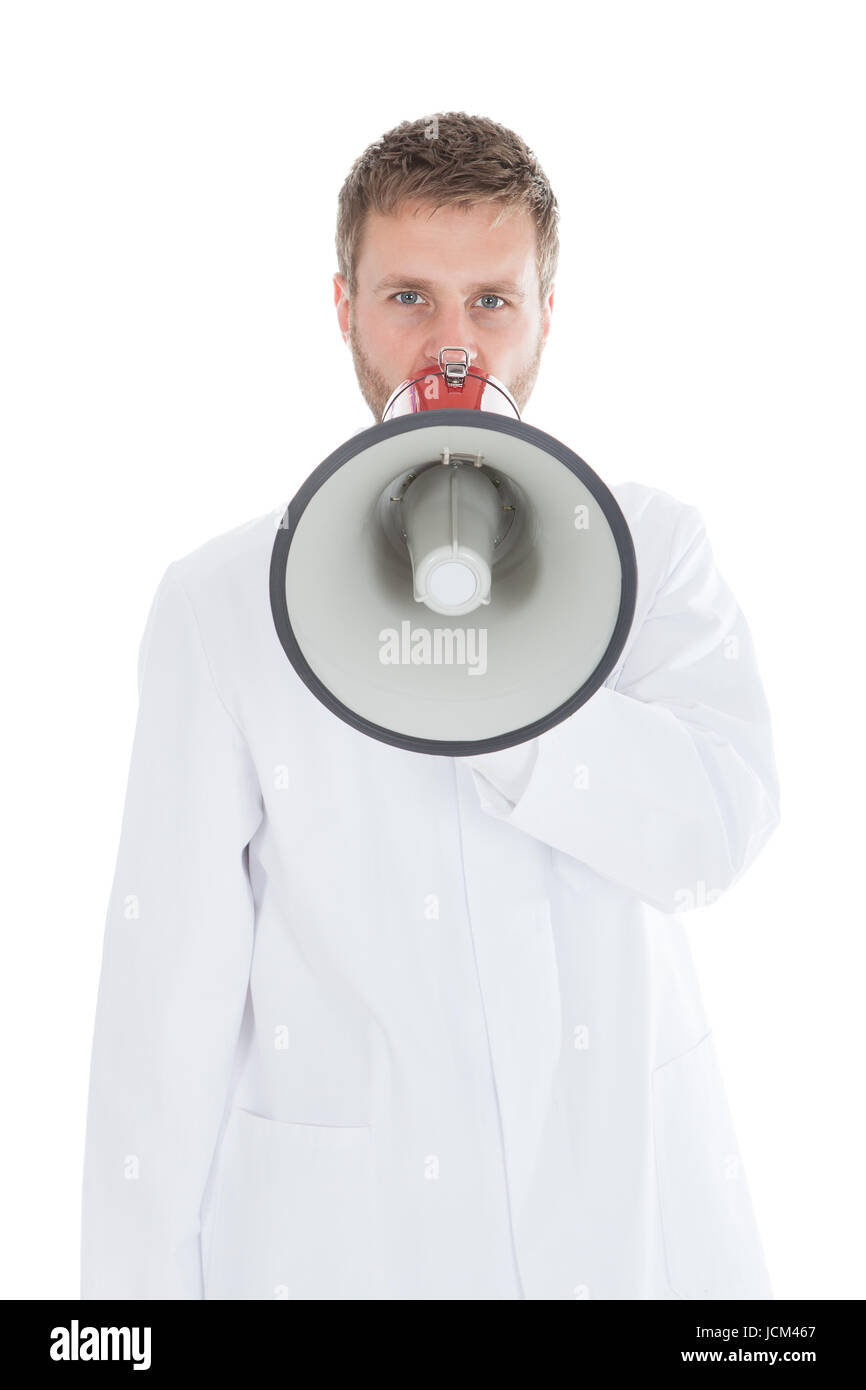 Young male doctor screaming into megaphone over white background Stock ...