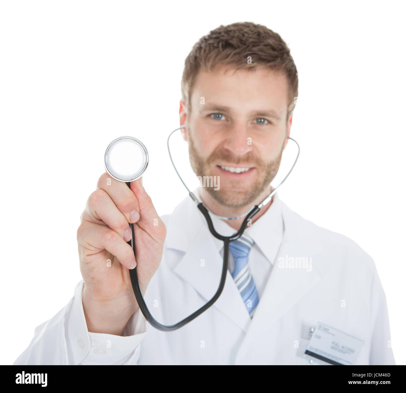 Portrait of mid adult doctor holding stethoscope over white background ...