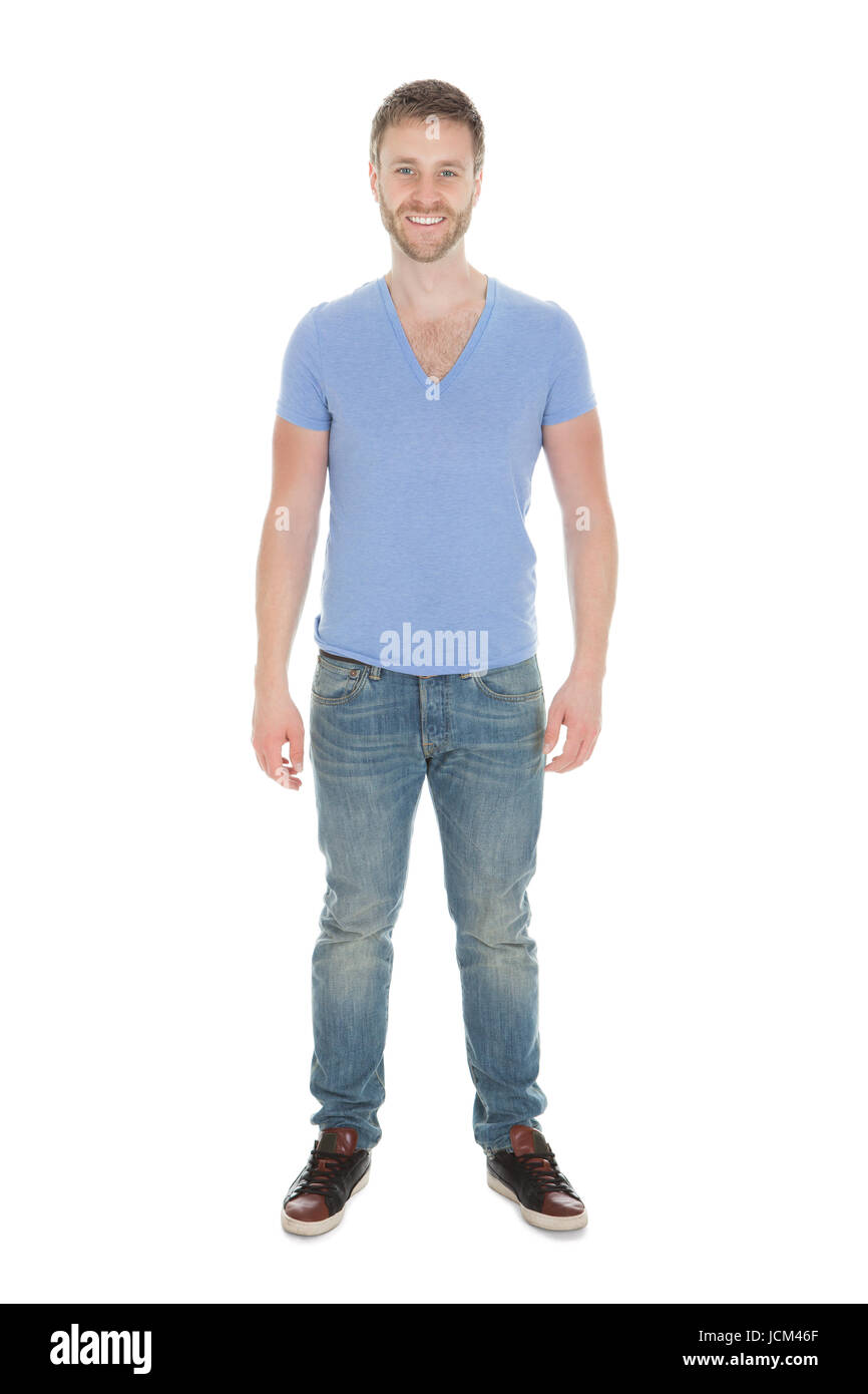 Full length of handsome mid adult man in casuals over white background ...