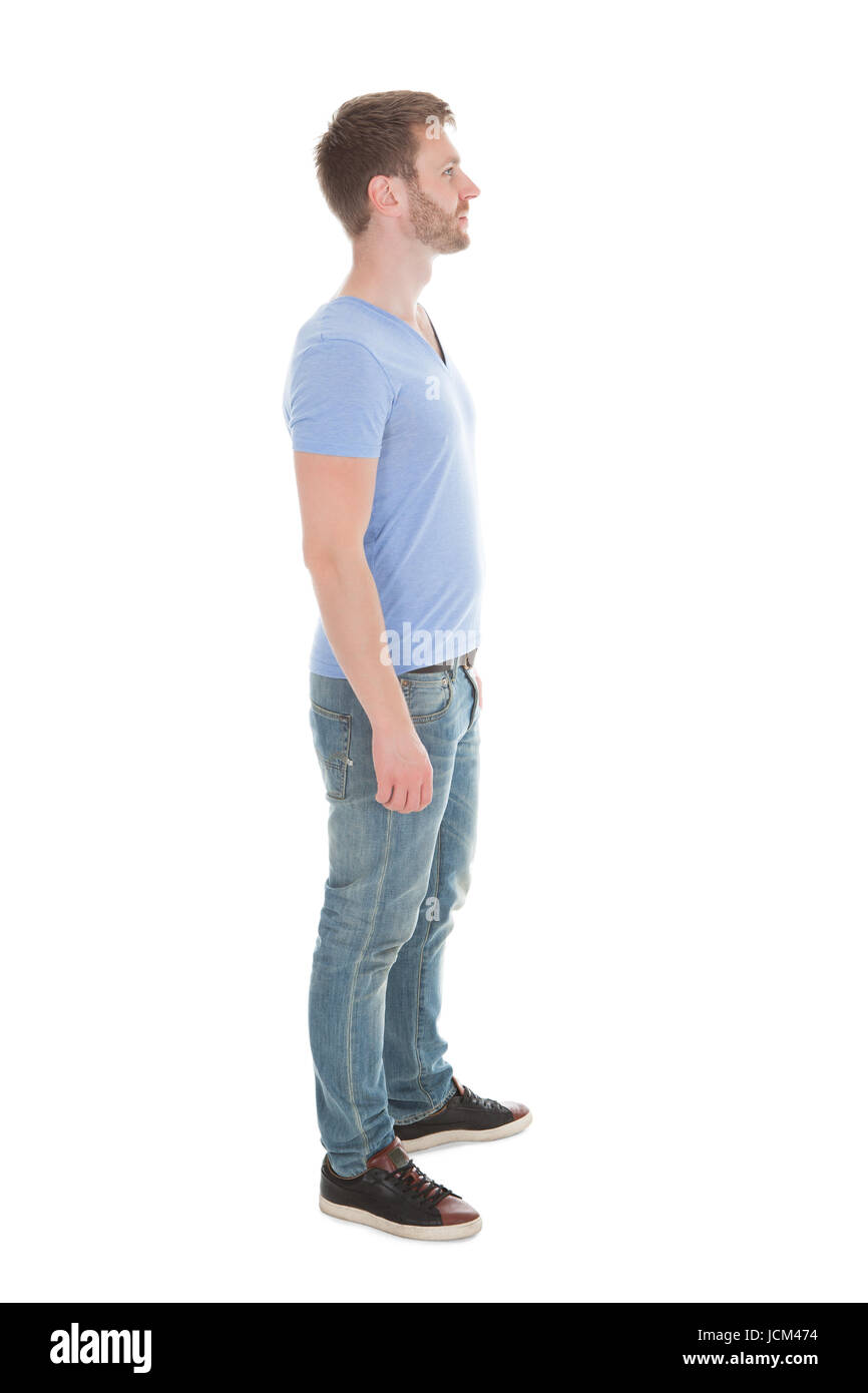 Full length side view of young man standing isolated on white ...
