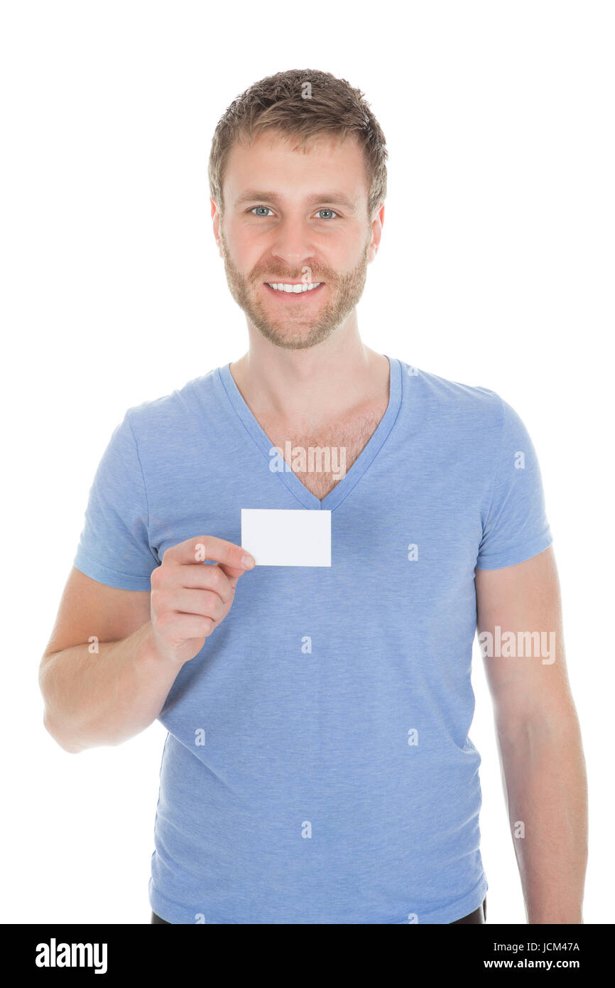 Portrait of confident man holding visiting card over white background ...