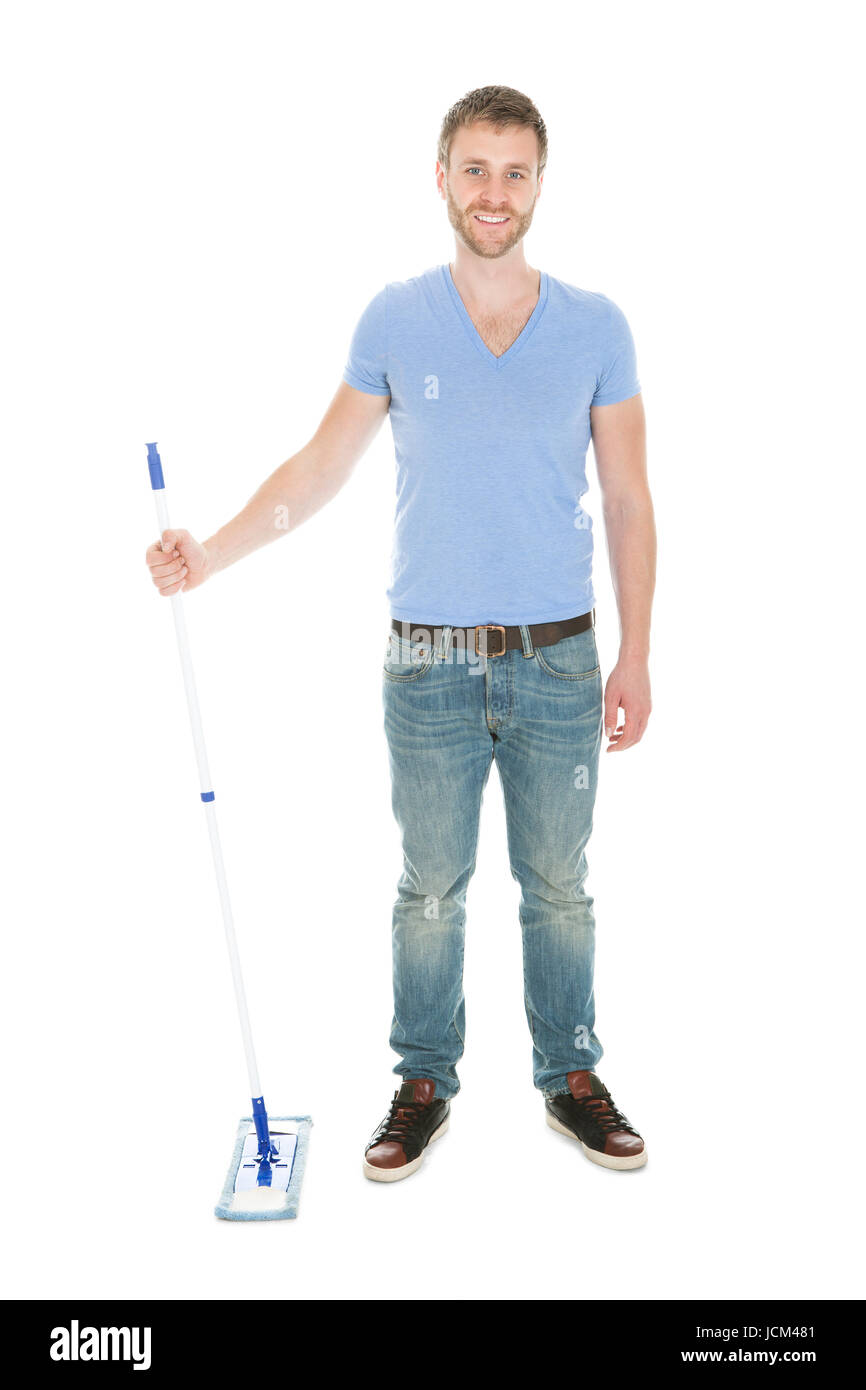 Full length portrait of happy man holding mop over white background ...
