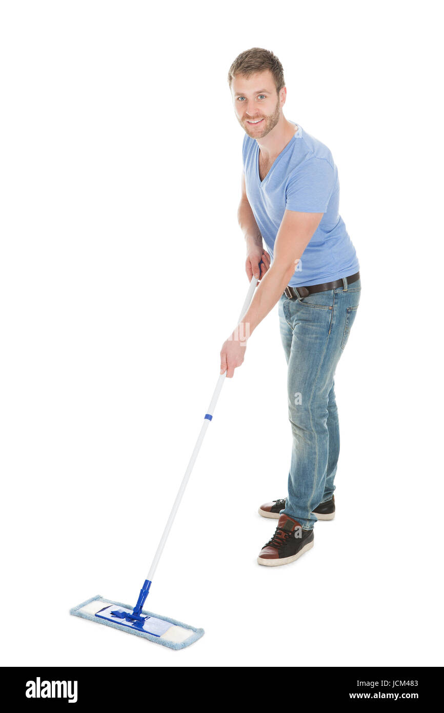 Full length portrait of happy man holding mop over white background ...