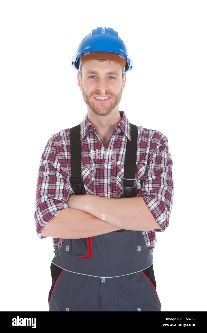 Full length portrait of manual worker standing with hands on hip over ...