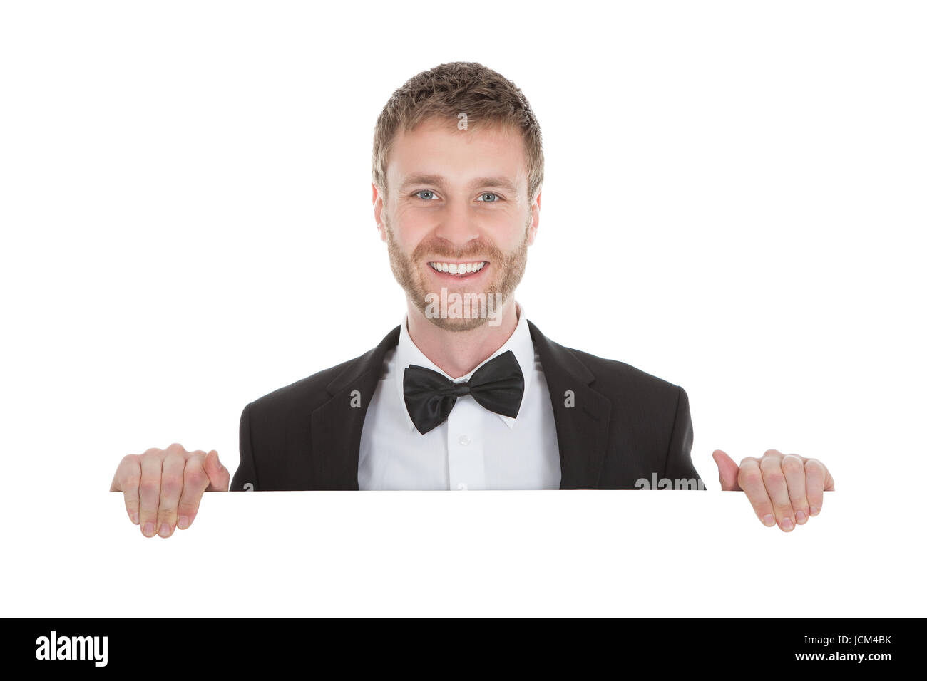 Young butler looking at blank billboard isolated over white background ...
