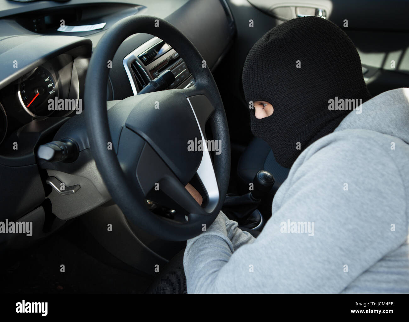 Side view of thief using screwdriver in car Stock Photo - Alamy