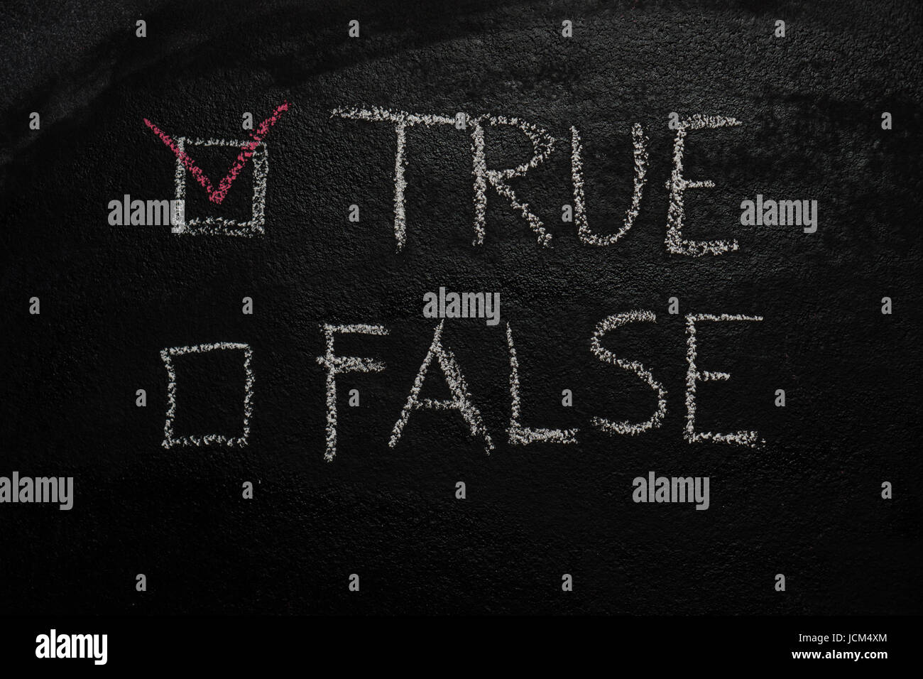 True or False written with white chalk on blackboard Stock Photo - Alamy