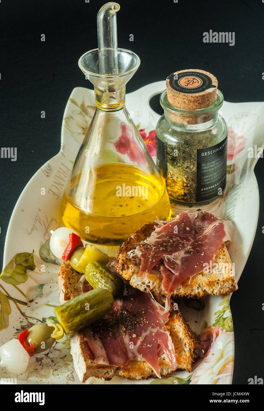 An appetezier snack, Iberic ham with olive oil and spices Stock Photo ...