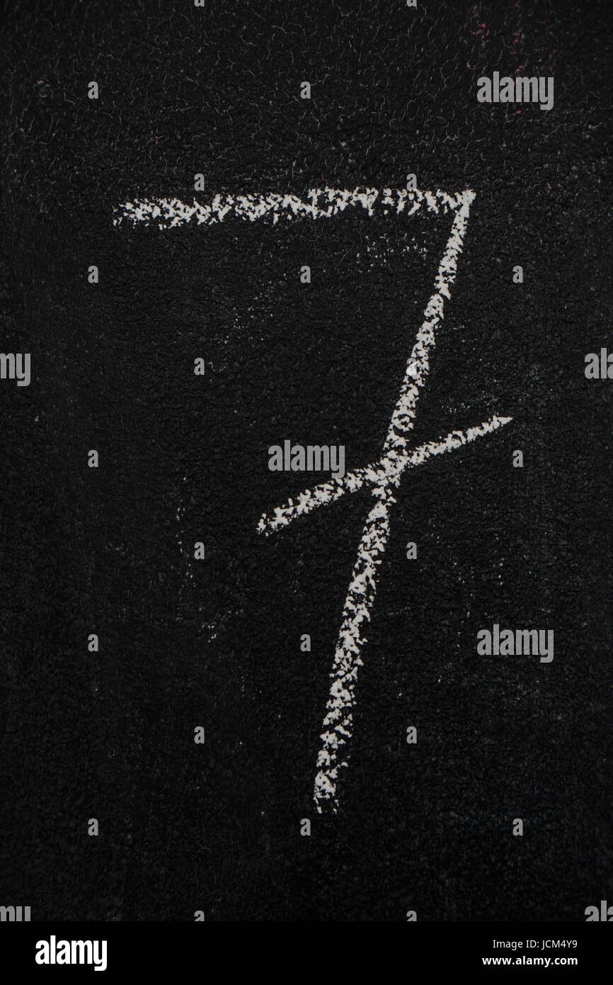 Number 7, seven drawn with white chalk on blackboard. Education, school ...