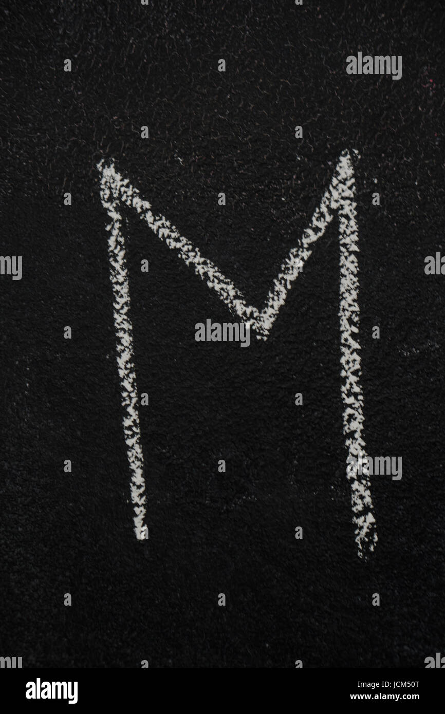 Letter M drawn with white chalk on blackboard. Education, school ...