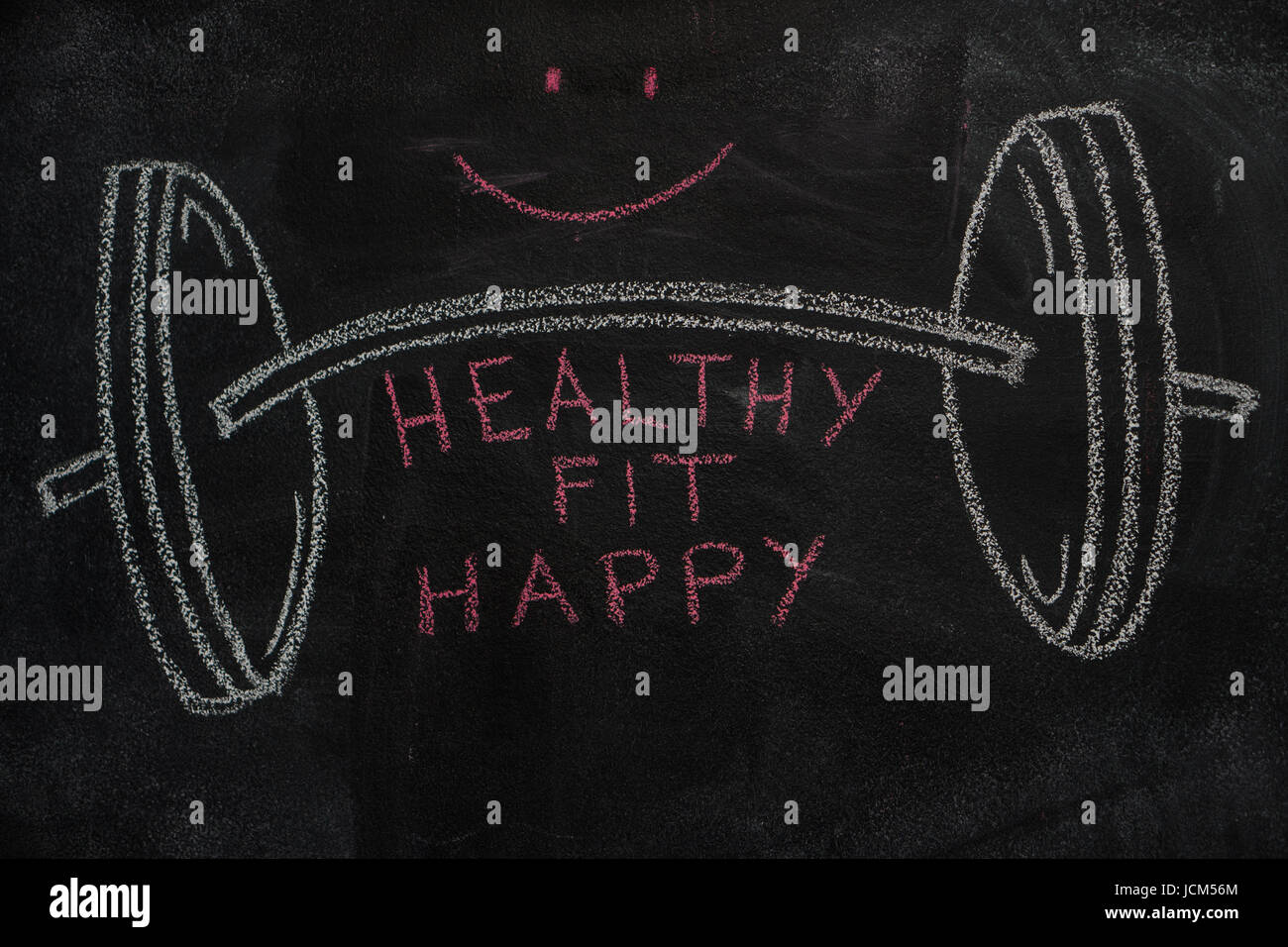 Barbell and healthy, fit, happy words drawn with chalk on blackboard ...