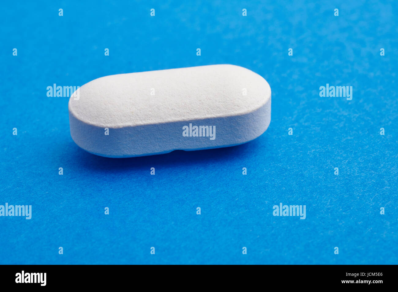 Pill over a blue background. Medicament treatment. Health care photo ...