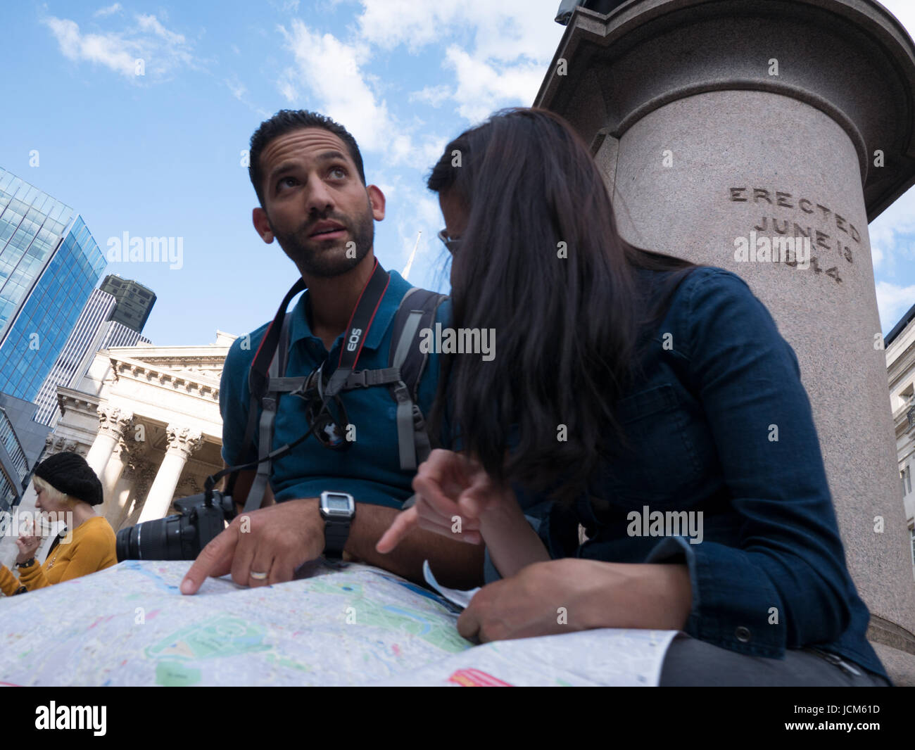 Tourist Couple reading map in Threadneedle street Central London Stock ...
