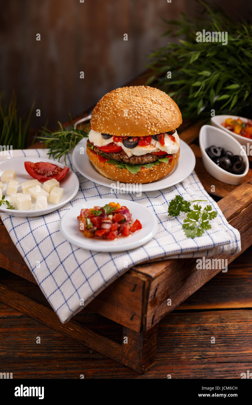 Delicious burgers with beef patty on rustic style background Stock ...