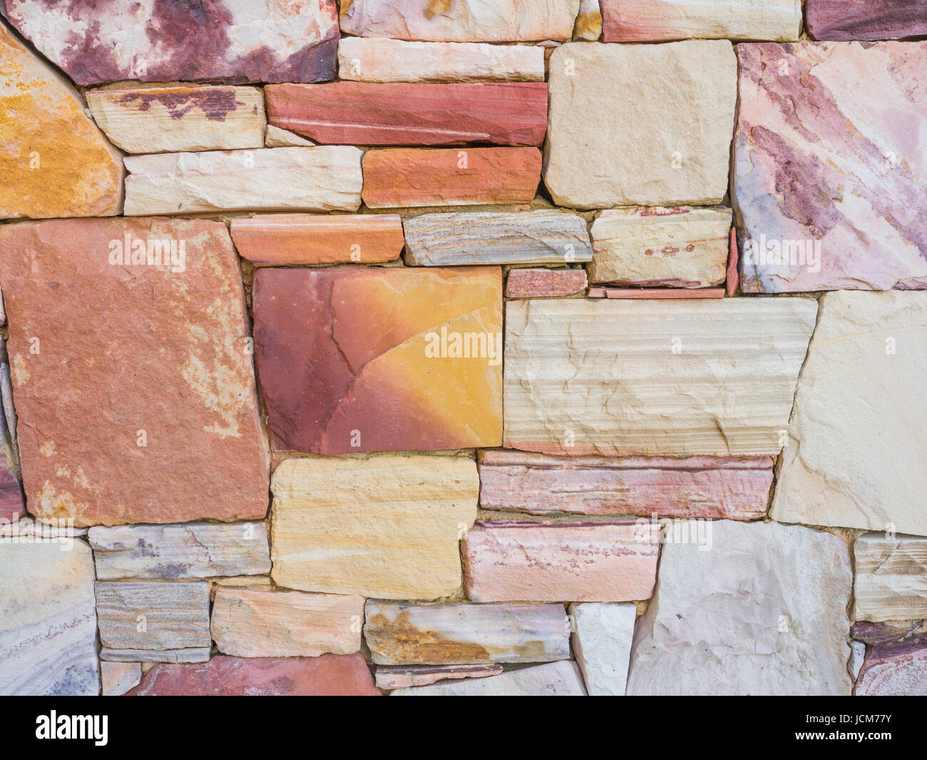 A rock wall background made from colorful Australian rocks Stock Photo ...